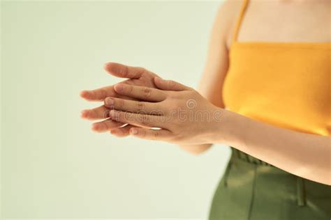 Close Up Of A Woman Rubbing Her Hands Together With Disinfectant Stock
