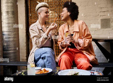A Diverse Beautiful Couple Of Lesbians Enjoying A Date Together In A Cozy Cafe Stock Photo Alamy