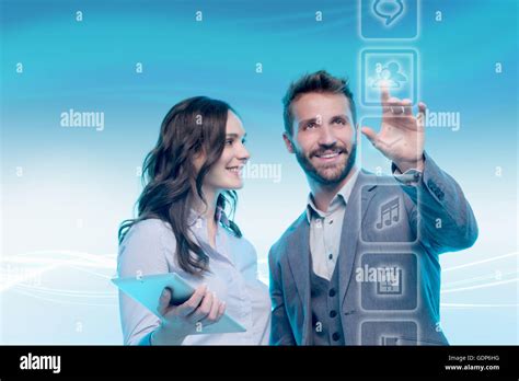 Man And Woman Using Graphical Screen Man Touching Icon Stock Photo Alamy