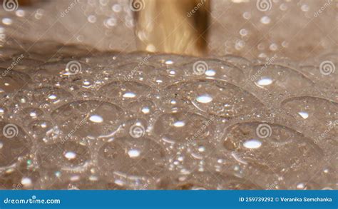 Foaming Liquid Pouring Container Closeup Carbonated Jet Streaming