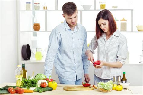 Loving Happy Couple Preparing Healthy Salad Of Fresh Vegetables In