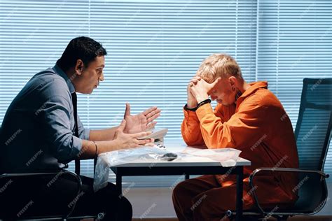 Premium Photo Emotional Detective Talking To Penitent Criminal In