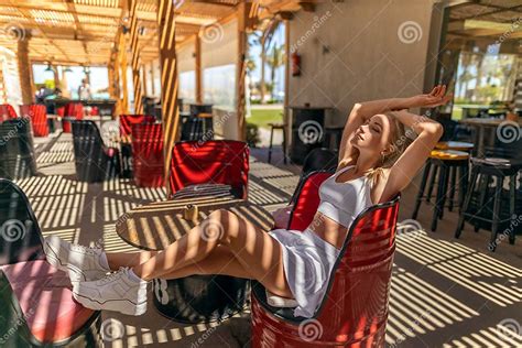 Beautiful Woman With Perfect Legs In White Dress Posing On The Midday