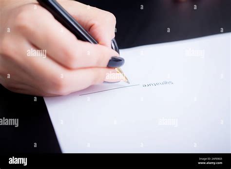 Close Up Girl Hand Putting Signature On Document She Situating At Desk Business Concept Low
