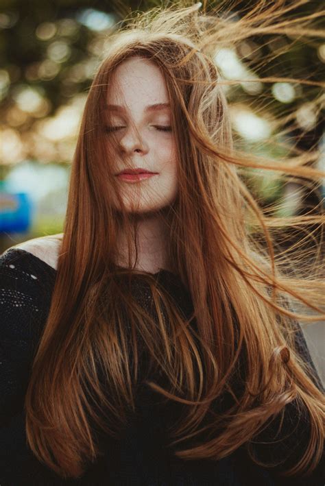 Young Redhead Standing Outdoors With Her Hair Messed By The Wind · Free