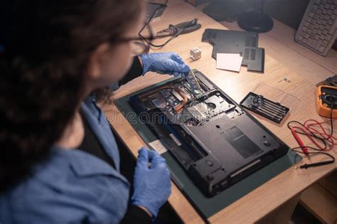 Repairman Girl Disassembling Laptop Motherboard And Install Memory Chip Engineer Fixing Broken