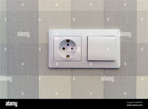Socket And Switch White On The Background Of Paper Wallpaper On The Wall Background Vertical