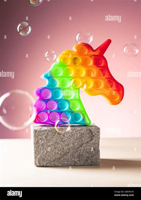 Pop It Toy Rainbow Colors In The Form Of A Unicorn On The Podium On A