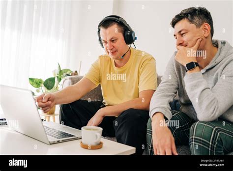 Two It Freelancer Men Typing In Laptop Working From Home Office Two Programmers Sitting On