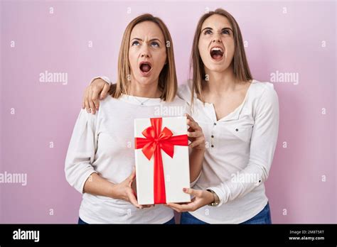 Middle Age Mother And Young Daughter Holding Mothers Day T Angry And