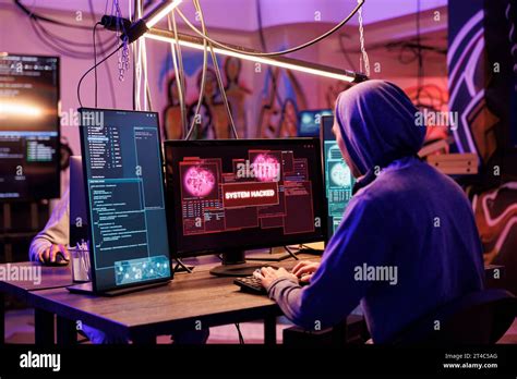 Criminal In Hood Successfully Hacking Into Computer System In Abandoned Warehouse Hacker