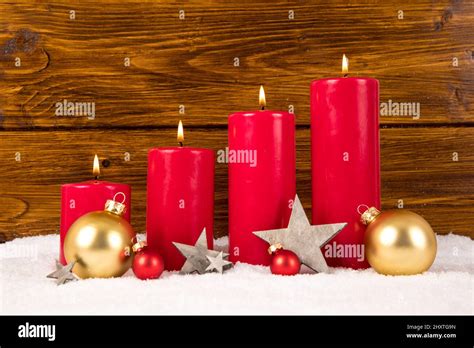 Christmas Concept With Red And Golden Balls Stars And Four Advent Candles On A Wooden
