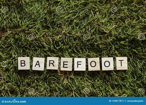 Barefoot Written With Wooden Letters Cubed Shape On The Green Grass