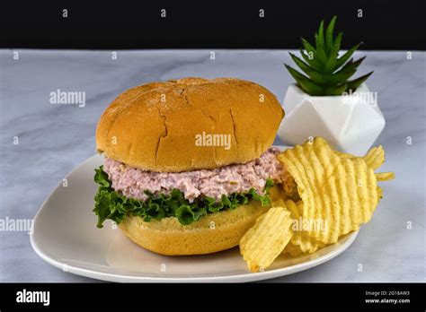 Ham Sandwich On A Lettuce Between A Bulkie Roll Served With Potato