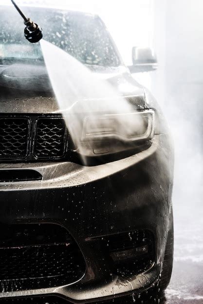 premium photo washing off foam from headlight using a highpressure