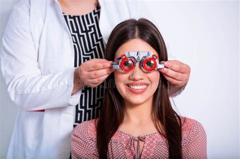 Ophthalmologist Examining Woman With Optometrist Trial Frame Female