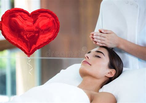 Composite Image Of Red Heart Shaped Foil Balloon Against Woman