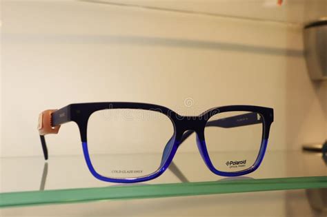 Electric Blue Rectangle Glasses On Glass Shelf Vision Care Eyewear