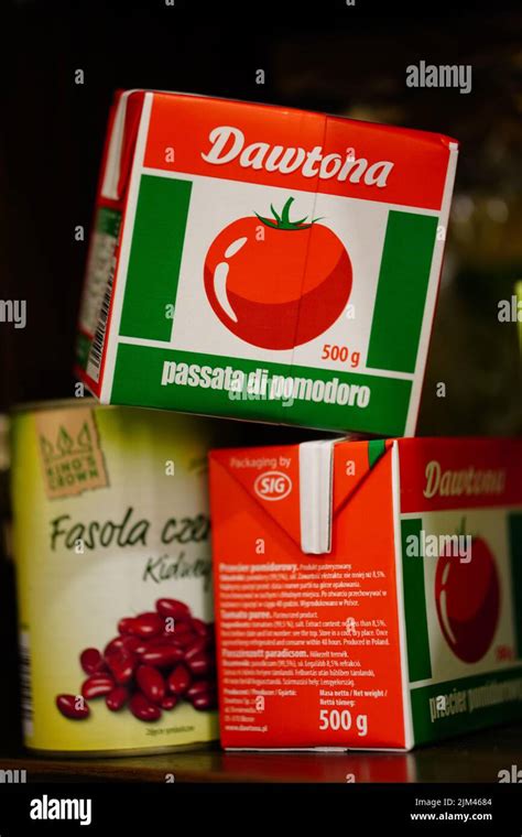A Vertical Shot Of Dawtona Brand Tomato Passata In Boxes On A Blurred