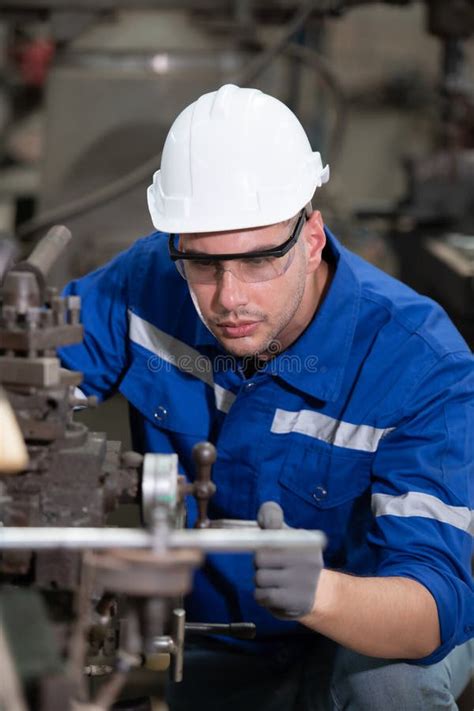 Young Experienced Engineers Are Maintaining And Testing The Operation Of Welding Robot Parts