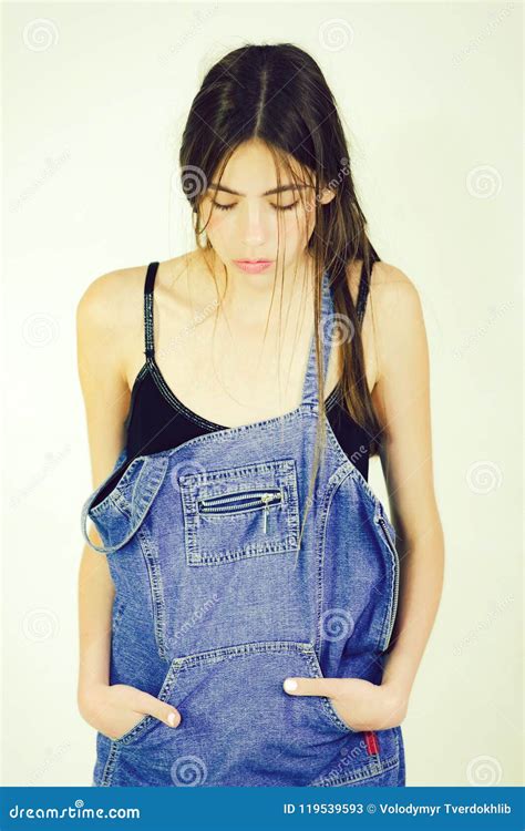 Fashionable Jeans Denim Woman With Long Brunette Hair In Long Jeans