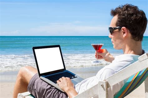 Premium Photo Man Sitting In A Deck Chair With A Laptop And A Glass