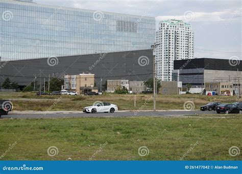Small Old Homes Dwarfed By A Large Modern Glass Building With Large