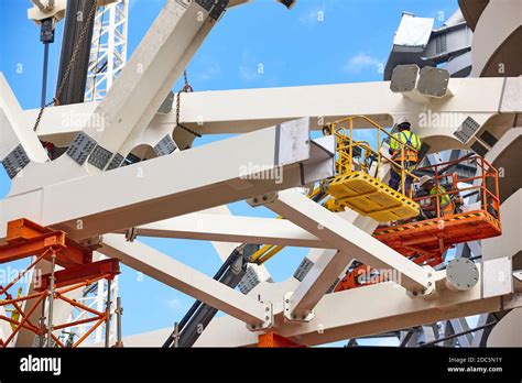 Workers On A Construction Site Engineering And Architectural