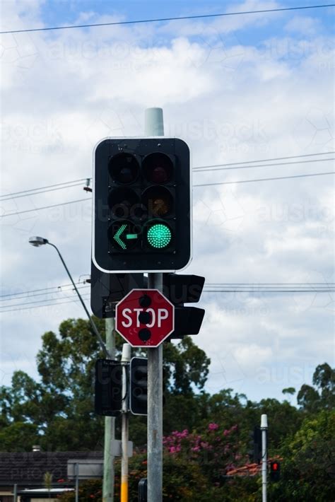Image Of Traffic Light With Green Arrow And Stop Sign At City