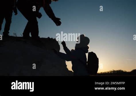 Travelers Climb One After Another On The Rock Teamwork Of Business
