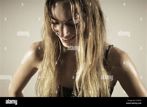 Young Woman Sweating In Sportswear Against Grey Background Smiling