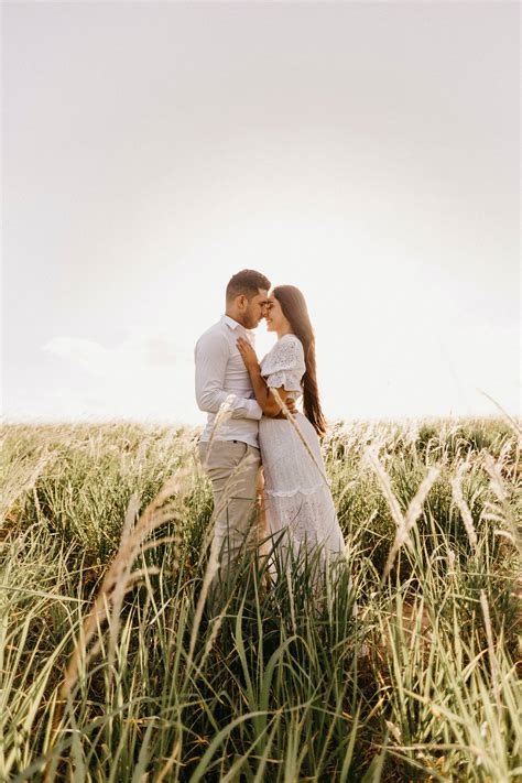 Download Romantic Couple On Grass Field Wallpaper