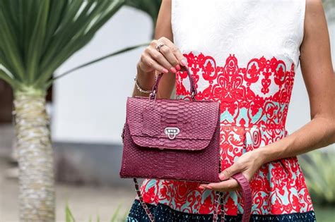 Premium Photo A Girl Stands Against A Background Of Tropical Trees