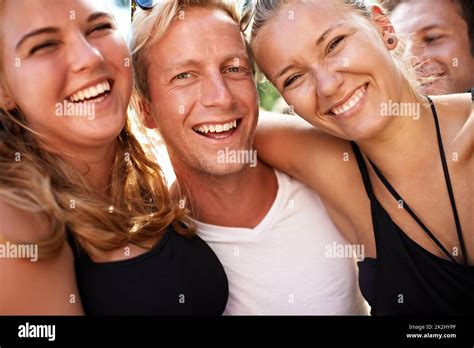 Surrounded By Sweet Smiling A Group Of Smiling Friends Enjoying Each Others Company Stock Photo