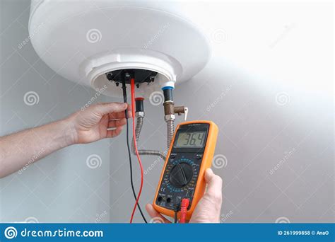 men using multimeter to test heating element appliance engineer using