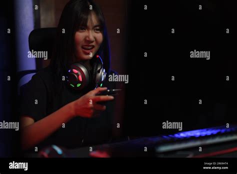 Female Cyber Hacker Gamer Using Controller Joystick To Playing Games On Computer With Serious