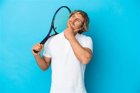Premium Photo Blonde Tennis Player Man Isolated On Blue Wall Having