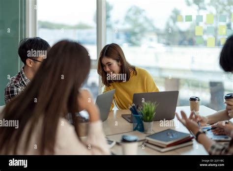 Young Asian Woman Leading Business Creative Team In Mobile Application Software Design Project