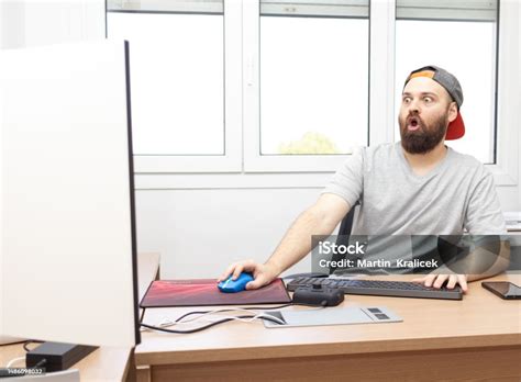 Pc 앞에서 놀란 개발자 거꾸로 모자를 쓴 수염 난 남자 책상에서 일하는 남자 공포 표현 30 34세에 대한 스톡 사진 및 기타 이미지 Istock