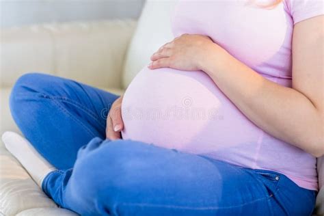 Close Up of Pregnant Woman Sitting on Couch Touching Her Belly Stock Image - Image of life ...