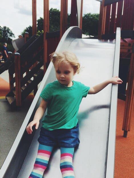Premium Photo Cute Girl Playing On Slide