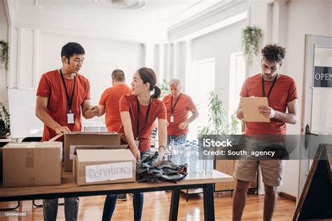 기부 센터의 자원 봉사자 팀 공유 및 포장 음식 옷 도움이 필요한 사람들을위한 상자에 물 개념에 대한 스톡 사진 및 기타 이미지