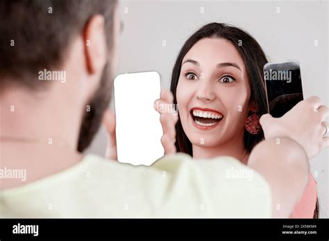 Energetic Sharing Of Digital Content Between Man And Woman Using Smartphone Visuals To