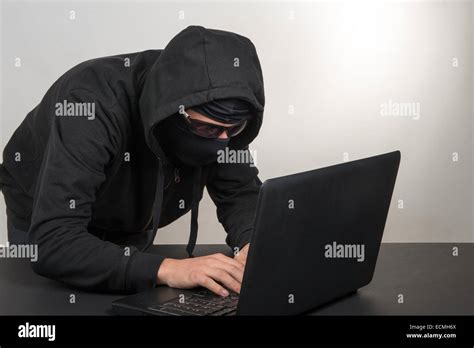 Hacker With A Hood And Black Goggles Stock Photo Alamy