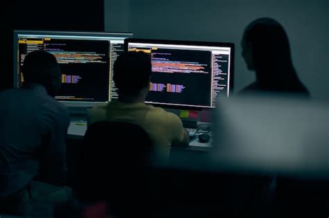 Premium Photo Programming Code And Computer With Business People In Office At Night For Cyber