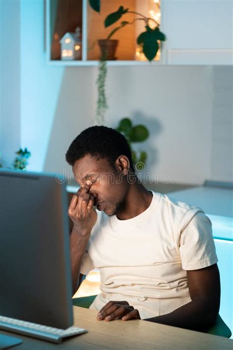 Tired Freelance Programmer Man Massage Nose Suffer From Eyestrain Working Remote At Computer At