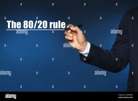 Pareto Principle Concept Man Writing 8020 Rule On Blue Background