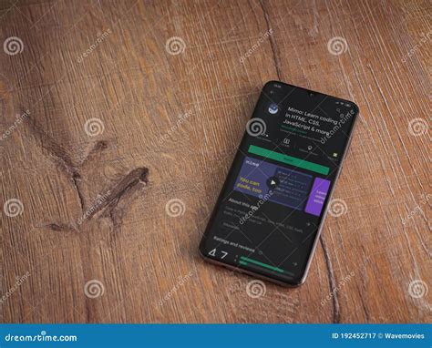 Mimo Learning Coding App Play Store Page On The Display Of A Black Mobile Smartphone On Wooden