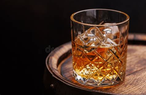 Whiskey Glass With Ice On A Rustic Barrel A Classic Sip Stock Image