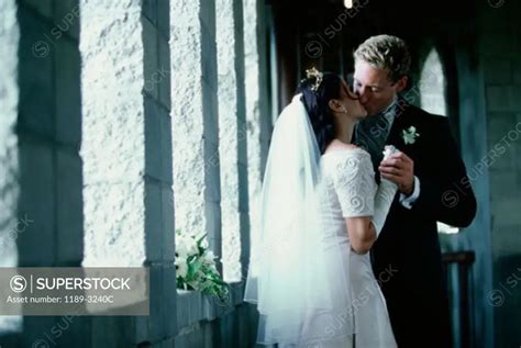 Newly Married Couple Kissing Superstock